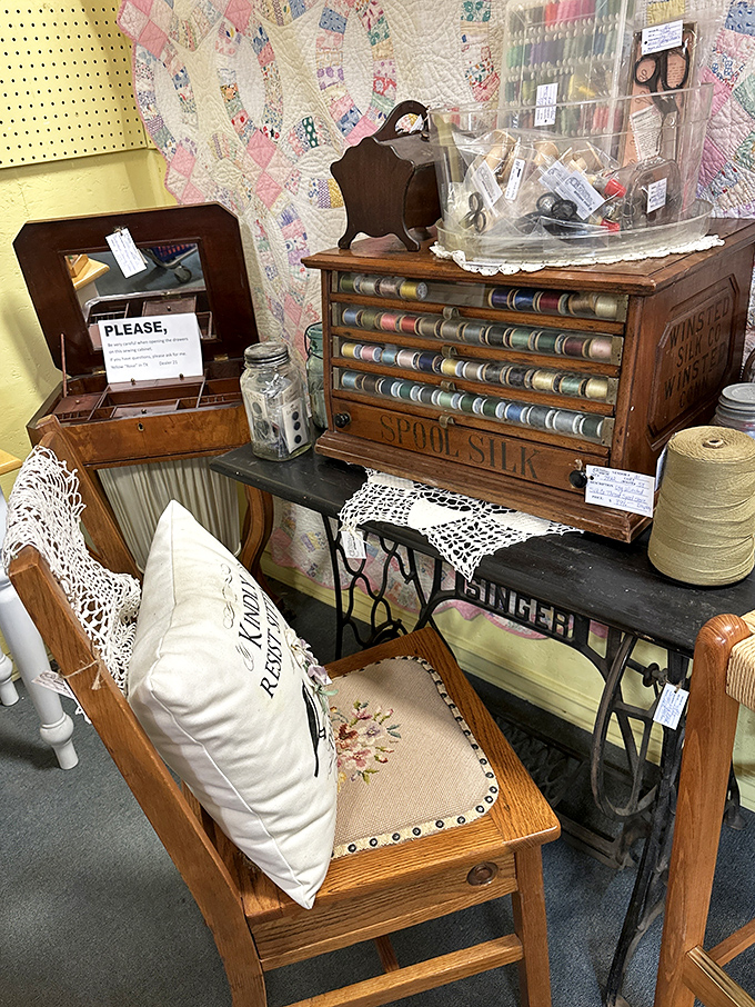 Grandma's sewing corner comes to life with this meticulously preserved thread cabinet. That wooden spool organizer has survived more fashion trends than Vogue.