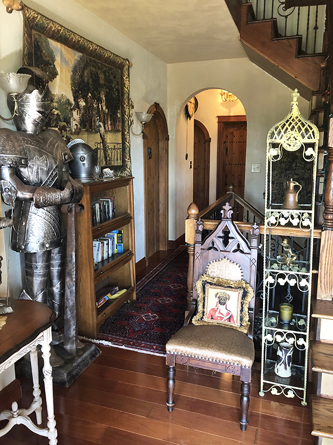 Step inside and the modern world dissolves. This entryway, complete with suit of armor and period-perfect details, sets the stage for time travel.