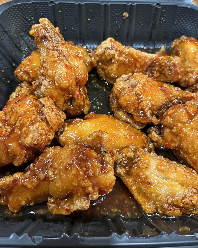 Golden wings glistening with sauce &ndash; proof that sometimes the best things come in the simplest packages.