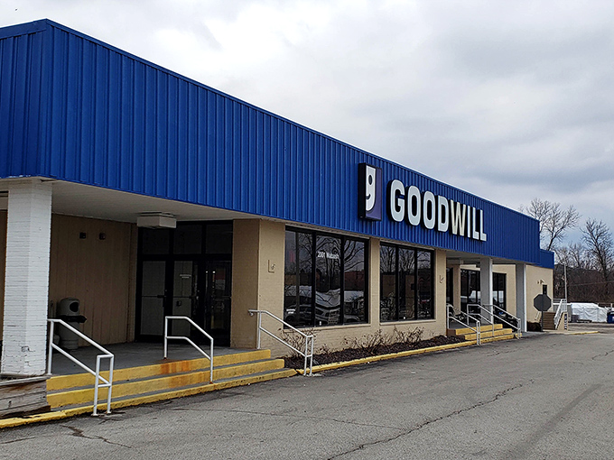 Goodwill's bold blue signage stands out against gray skies, beckoning shoppers to explore its cavernous interior.