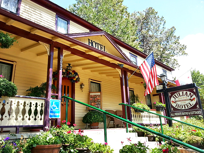 Julian Hotel's cheerful yellow facade and welcoming porch invite you to slow down and stay awhile. The American flag adds a touch of small-town pride.