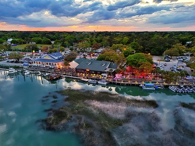 Murrells Inlet at sunset transforms into a waterfront paradise where boats gently rock in golden light.