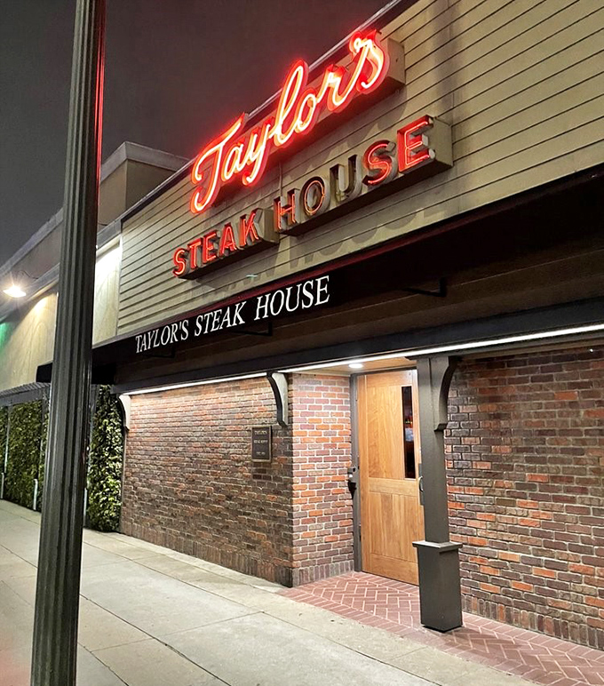 That classic red neon glow against brick walls screams old-school Los Angeles steakhouse - where legends are made and appetites satisfied.