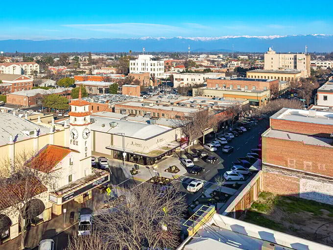 Visalia from above reveals itself as a perfect grid of possibility, with the Fox Theatre sign standing as a beacon for entertainment seekers.