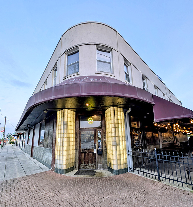That curved corner entrance with gold columns hints at the burger royalty inside. 80/20 knows architecture and beef in equal measure.