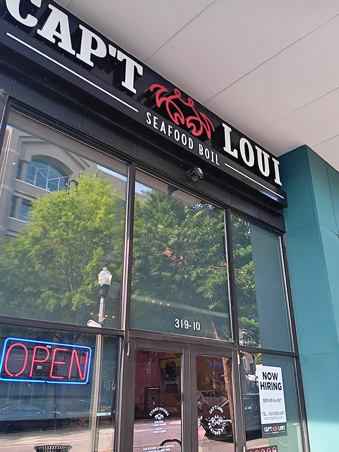 The glowing "OPEN" sign is your beacon to seafood paradise. Cap't Loui's contemporary facade houses plastic bags of garlicky, buttery treasure.
