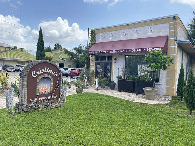 That stone sign whispers promises of coal-fired perfection waiting just beyond the entrance.