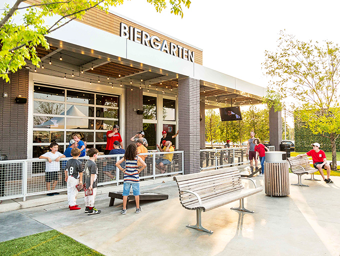 Families gather on Dog Haus Biergarten's sunny patio, where premium hot dogs and good times are always on the menu.