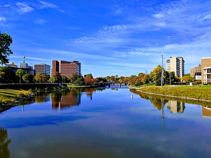 The Grand River flows gently through Flint, reflecting blue skies and offering peaceful views for residents enjoying Michigan's affordable capital city.