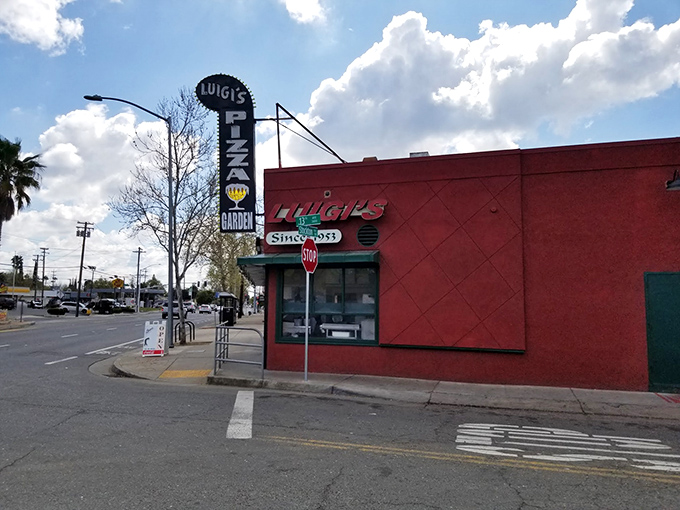The classic red building houses decades of pizza history, where locals have celebrated life's moments one slice at a time.