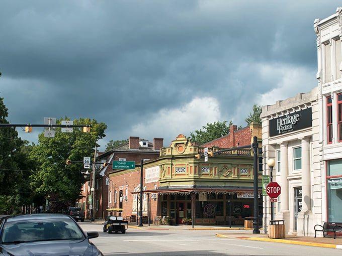 Storm clouds gather dramatically over New Harmony's historic buildings, adding theatrical lighting to this living museum of a town.