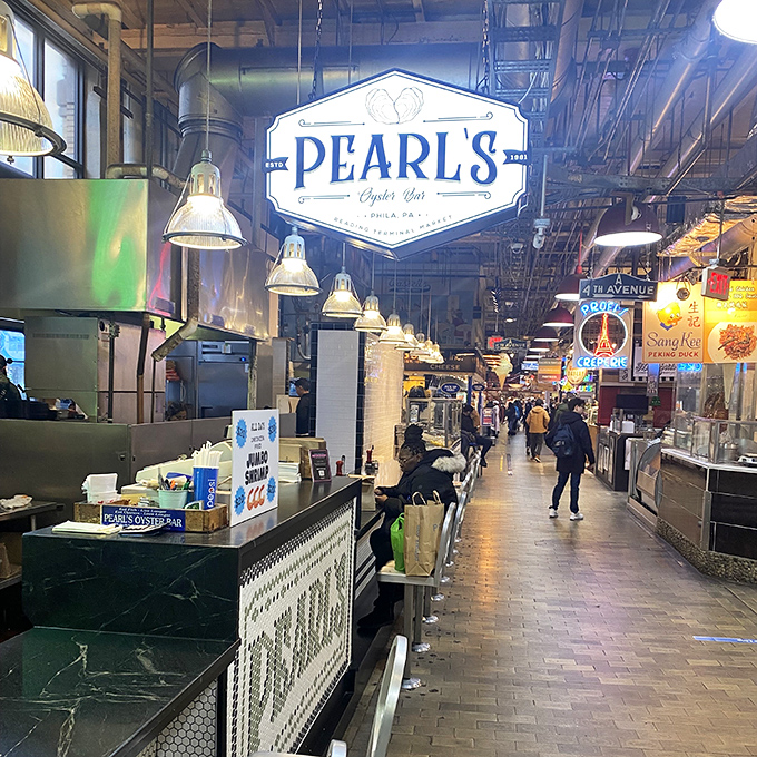 Reading Terminal's bustling energy flows around Pearl's, where oysters glisten like jewels under industrial pendant lights.