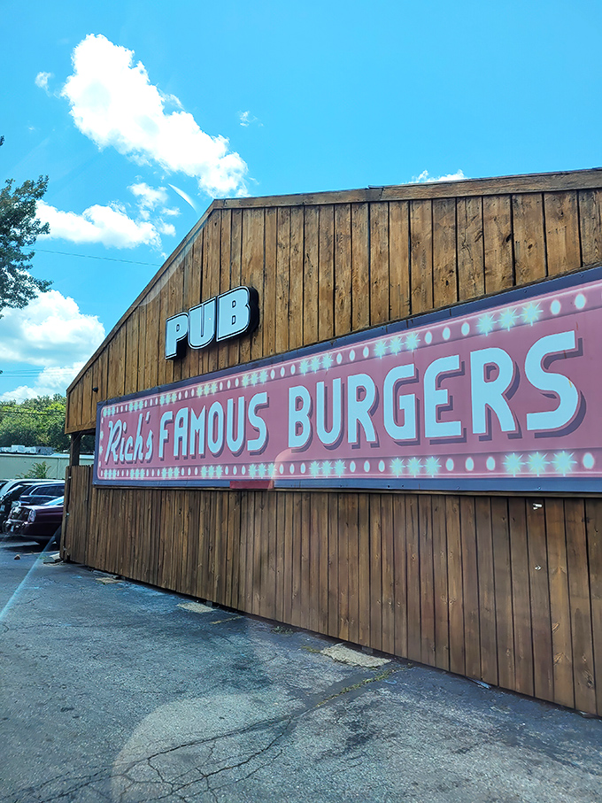 That pink neon sign glowing against weathered wood is like a treasure map&mdash;X marks the spot for burger gold.