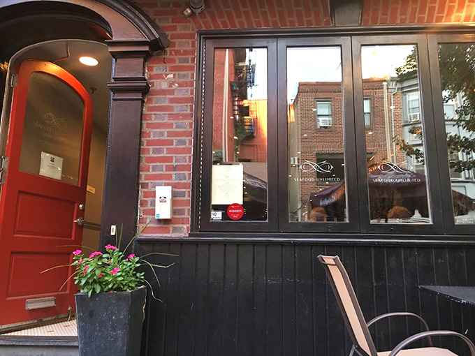 Seafood Unlimited (entrance): "That red door isn't just an entrance&mdash;it's a portal to seafood paradise hiding in Philadelphia's charming streets!"
