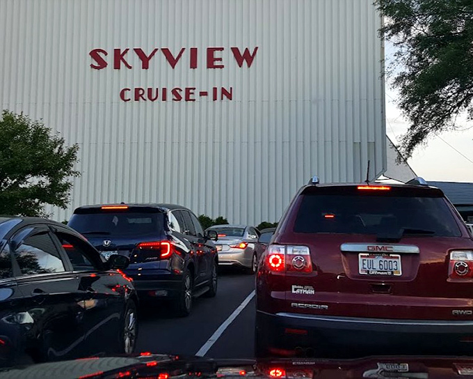 The crowd gathers as sunset approaches, that magical moment when the screen comes to life against the twilight sky.