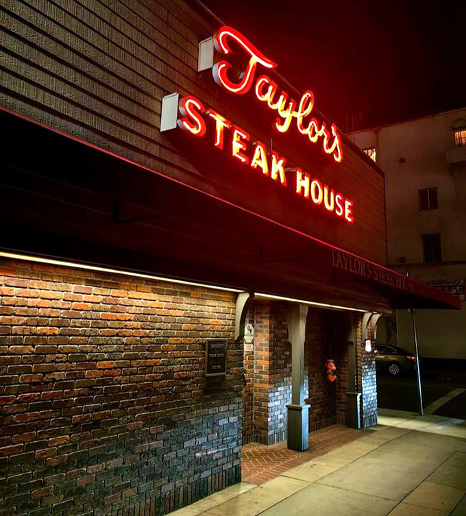 Taylor's nighttime facade glows like a beacon for serious carnivores who appreciate timeless steakhouse elegance and perfectly grilled beef.