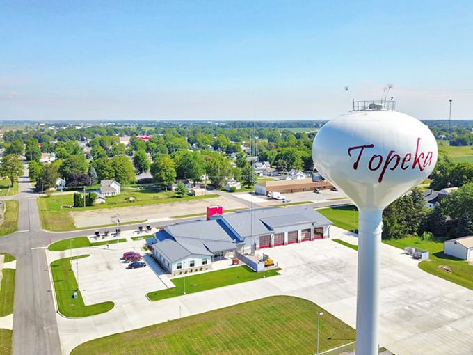 Topeka's water tower stands tall over a community that values both tradition and tomorrow. The town's name proudly displayed is like a welcome sign from the sky.