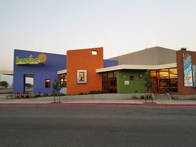 Splashes of color bring desert life to this modern building. Like finding a box of crayons in a world of beige.