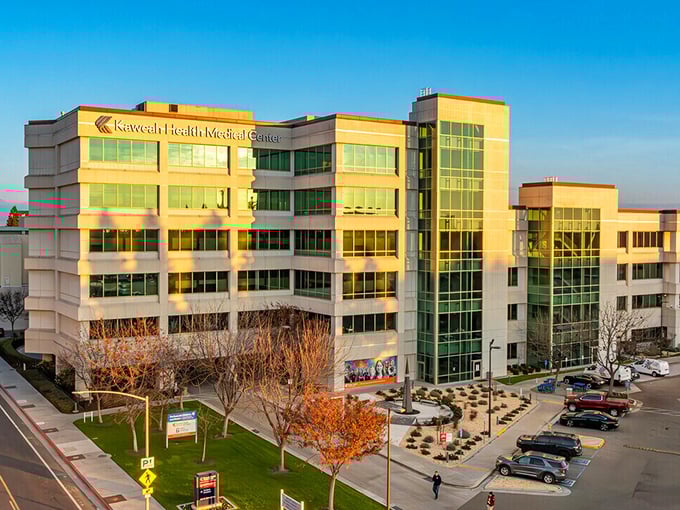 Kaweah Health Medical Center gleams in golden hour light&mdash;where modern healthcare meets California sunshine.
