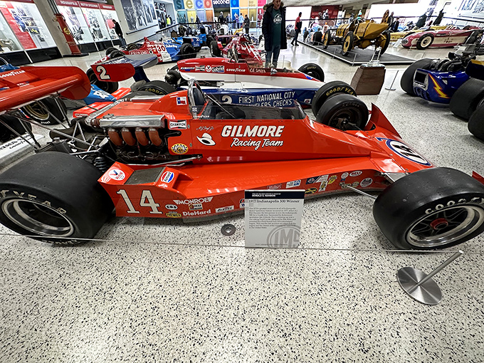 A.J. Foyt's iconic Gilmore Racing Team car #14 sits in quiet glory, its vibrant orange paint still looking fast even while perfectly still.