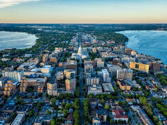 From above, cities reveal their true character. This aerial view shows a metropolis embracing its waterways like old friends at a high school reunion.