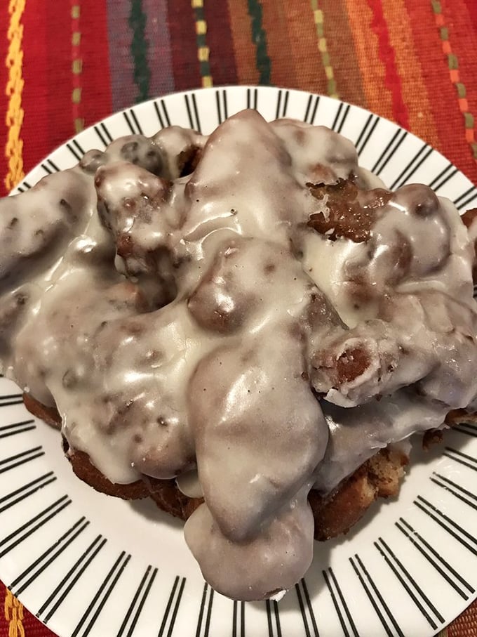 This isn't just a fritter&mdash;it's an architectural marvel of glazed peaks and valleys, crowned with a vanilla waterfall that defies vegan expectations.