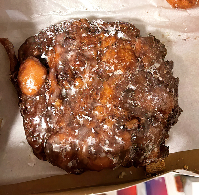 Not so much a fritter as a monument to excess. This apple-studded masterpiece has more nooks and crannies than an English muffin convention.