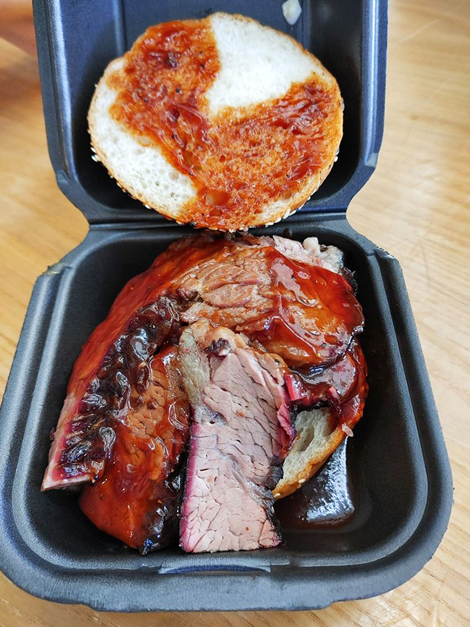Behold the brisket in all its glory—that pink smoke ring is like nature's way of applauding the pitmaster's patience.