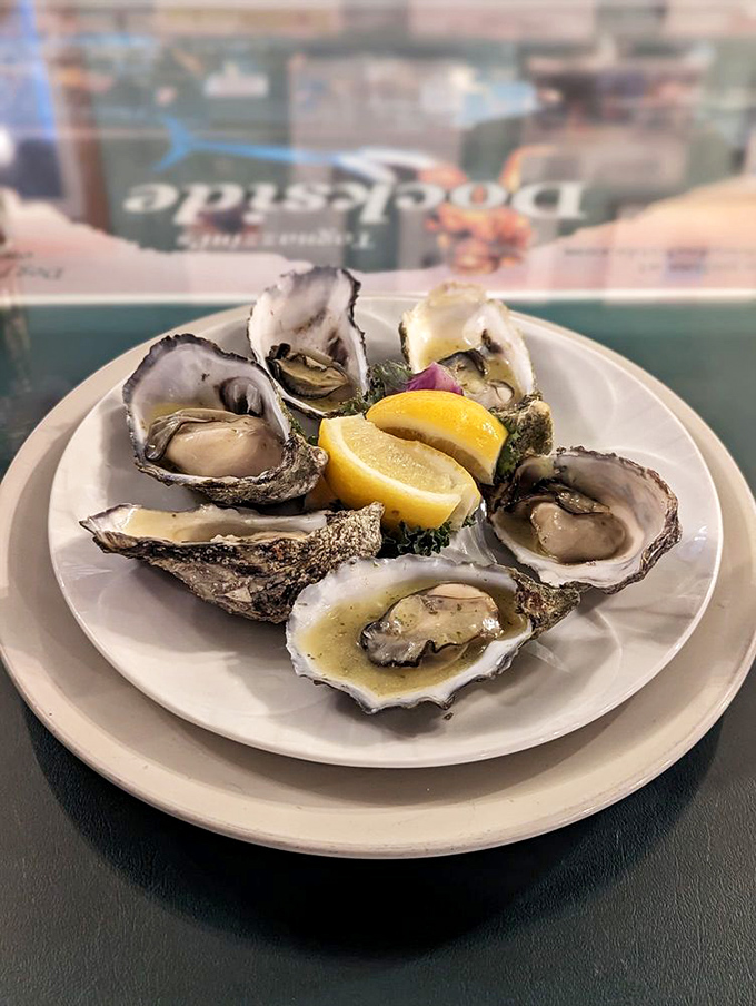 These oysters aren't just served, they're presented—plump, glistening treasures from the sea arranged around lemon wedges like a delicious clock face.