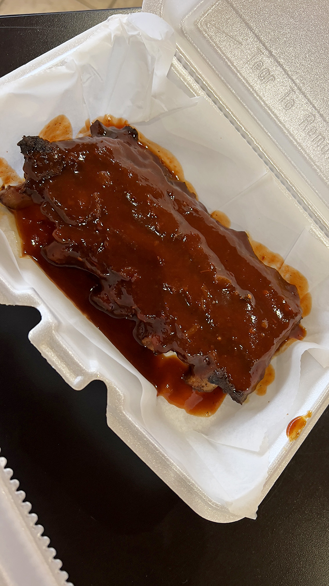 These sauce-slathered ribs aren't just food&mdash;they're an edible love poem to patience. The glossy coating promises a sweet-tangy symphony that'll have you licking your fingers shamelessly.