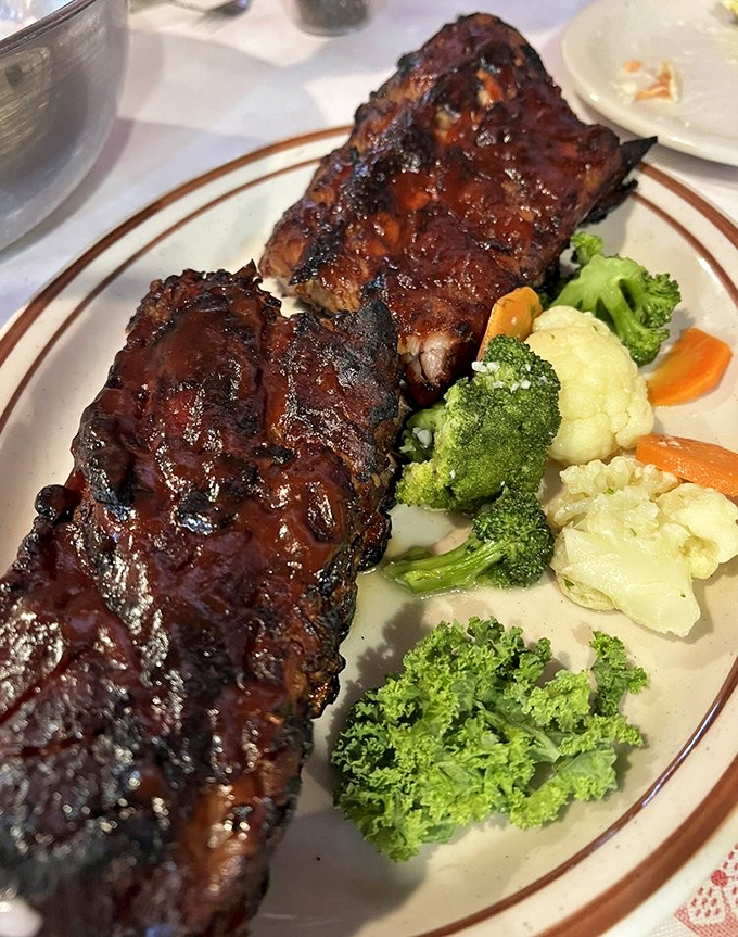 Baby back ribs so tender they're practically falling off the bone, glazed with a sauce that strikes that perfect sweet-tangy balance. Vegetables included for plausible deniability.