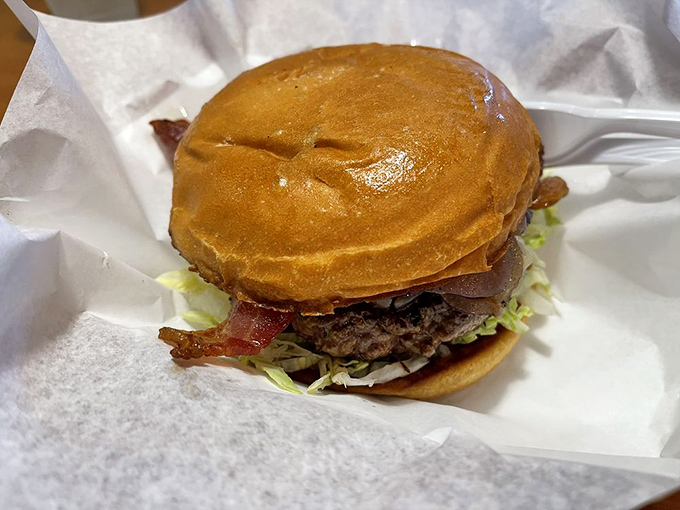 The bacon cheeseburger arrives like a beautiful meat monument&mdash;perfectly grilled patty, crisp bacon, and a bun that's somehow both sturdy and yielding.
