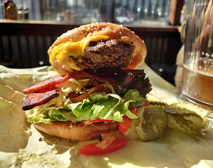 This towering creation defies gravity and good manners. Some sandwiches you eat; this one you conquer, layer by magnificent layer.