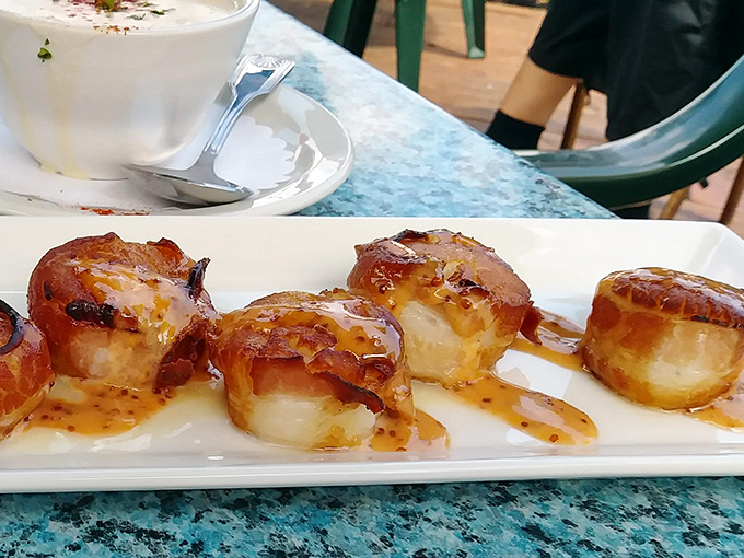 Bacon-wrapped scallops glistening with caramelization&mdash;ocean meets farm in perfect harmony. These little flavor bombs could make a pescatarian question their life choices.