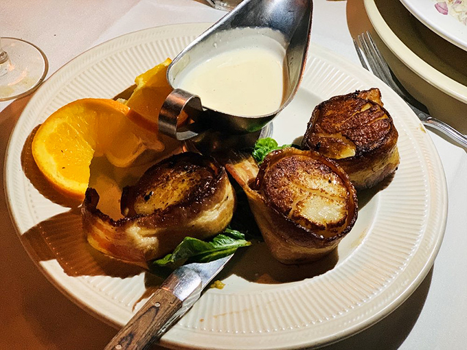 Bacon-wrapped medallions that would make vegetarians question their life choices, served with a sauce worth bottling and taking home.