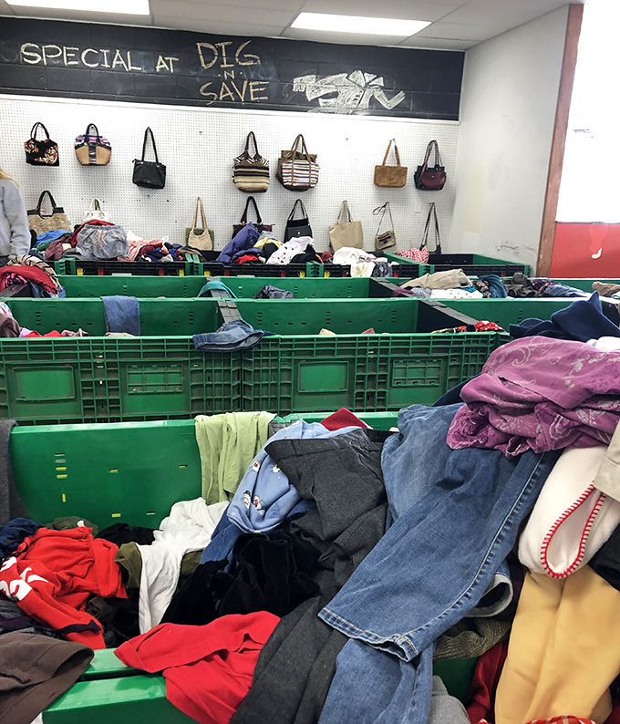 The handbag wall of fame hovers above textile mountains. Fashion archaeology at its finest—dig deep enough and designer labels appear.