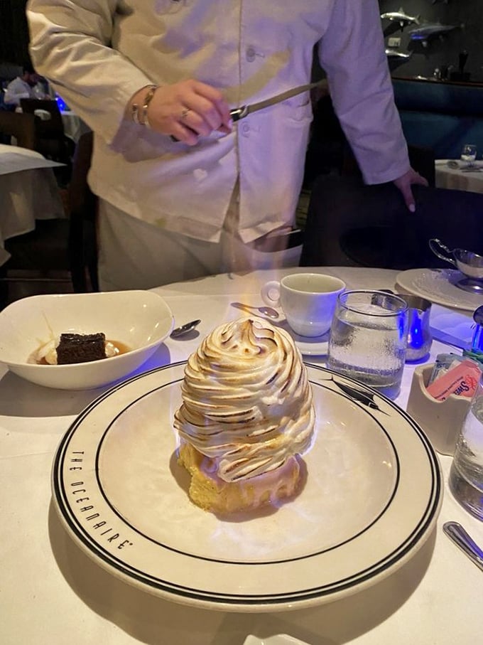 The Baked Alaska arrives like a meringue-capped mountain, ready for tableside torching. Dessert and dinner theater in one glorious package.
