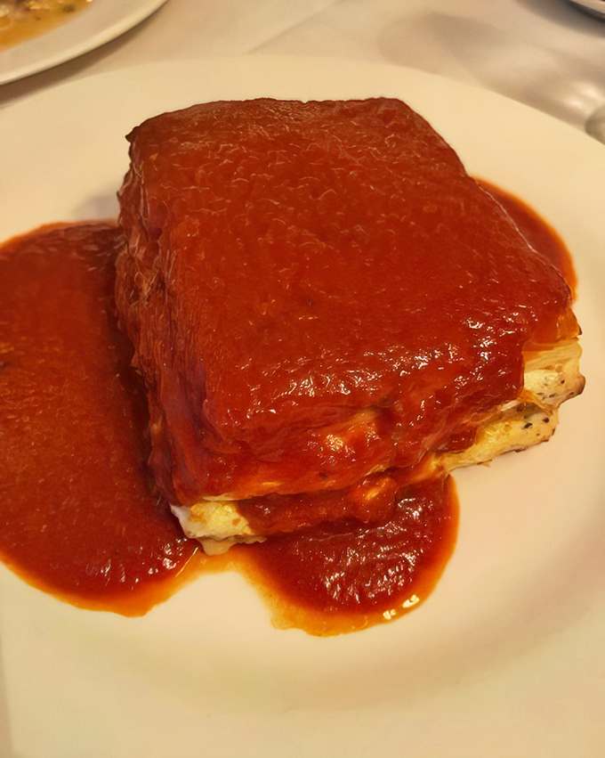 Lasagna that doesn't know the meaning of restraint. That red gravy blanket is the comfort food equivalent of a warm hug from Tony Soprano.