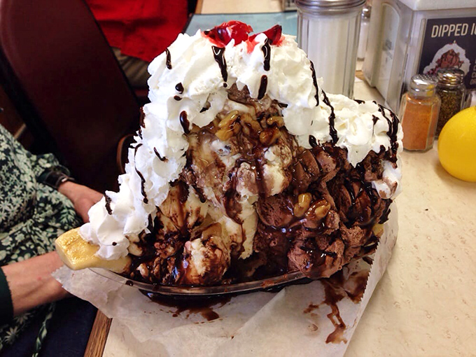 Not just a banana split—it's a monument to excess that would make Elvis proud. Whipped cream mountains atop chocolate rivers flowing over ice cream valleys.