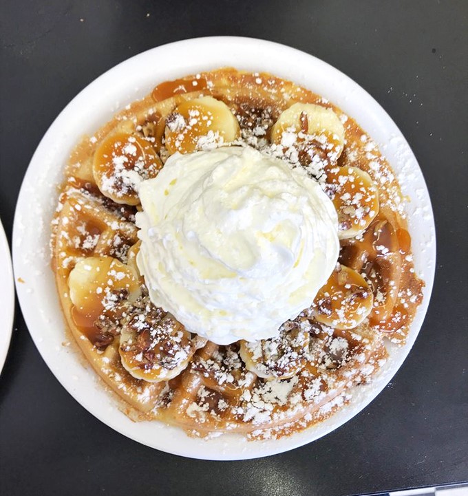 This banana-topped waffle with whipped cream isn't just breakfast &ndash; it's what dessert dreams about becoming when it grows up.