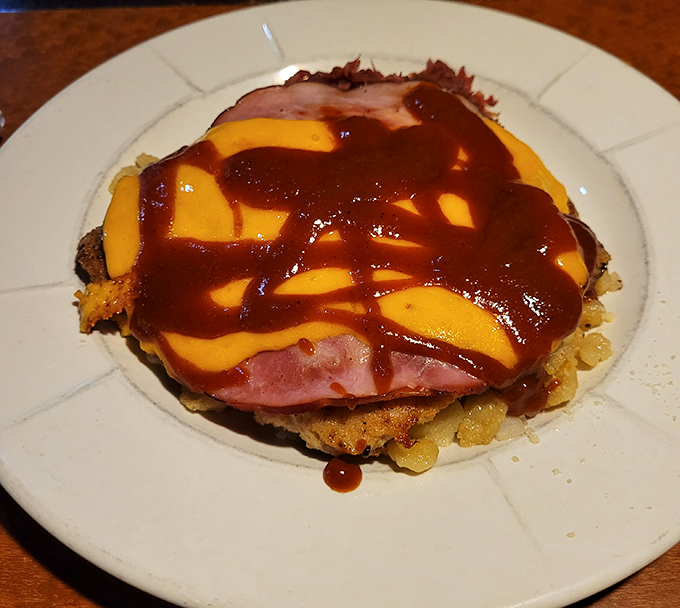 Behold the Baltic Schnitzel in all its glory&mdash;a crispy pork cutlet playing dress-up with ham, melted cheese, and a saucy drizzle that makes you want to applaud.