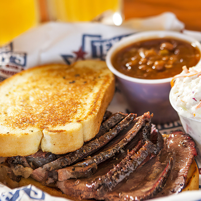 Brisket so tender it practically surrenders to your fork, paired with Texas toast that's the perfect sauce-sopping companion.