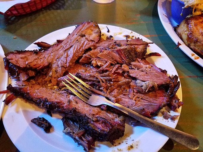 Brisket so tender it practically surrenders to your fork&mdash;the pink smoke ring is nature's way of saying "you're welcome."
