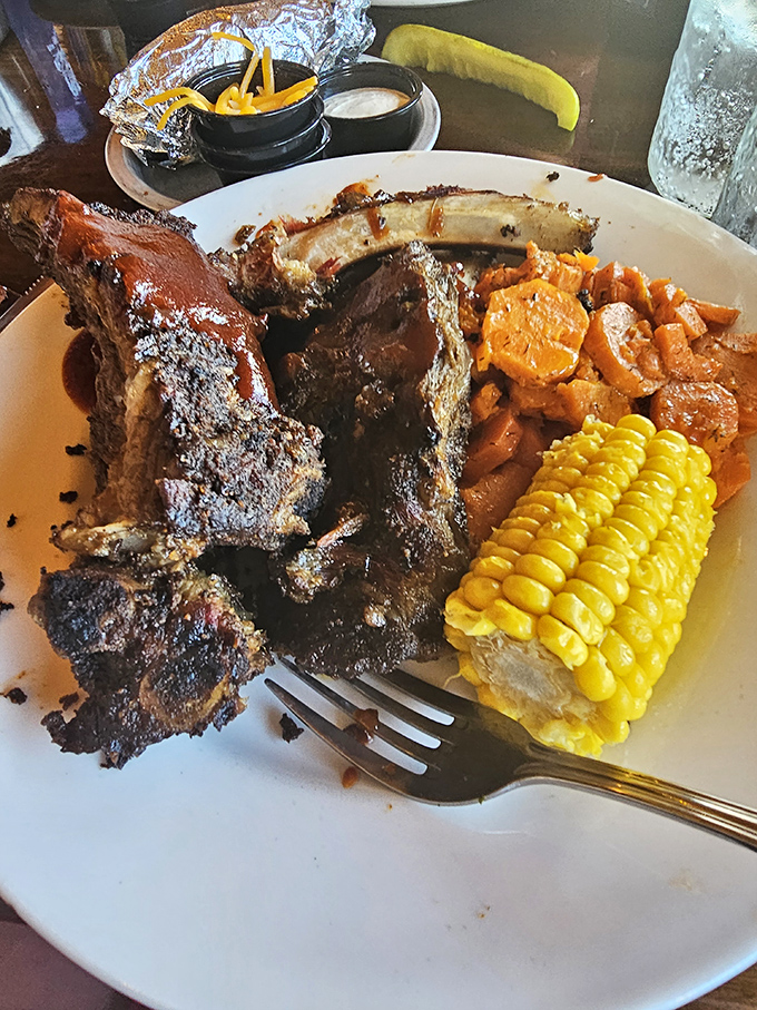 These beef ribs arrive looking like they belonged to a particularly well-fed dinosaur, smoked to perfection.