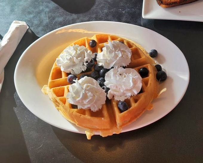 Belgian waffles standing tall like golden skyscrapers ready for their syrup shower.