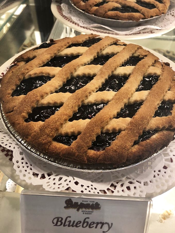 Lattice-top blueberry pie that would make your grandmother both proud and suspicious you stole her recipe. The filling-to-crust ratio is mathematical perfection.
