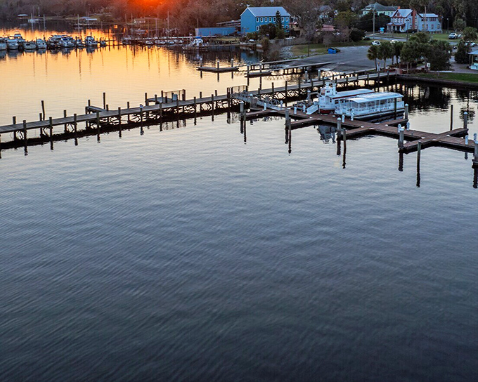 Sunset paints the marina in golden hues, where boat slips cost less than a parking space in Miami. Florida living as it should be.