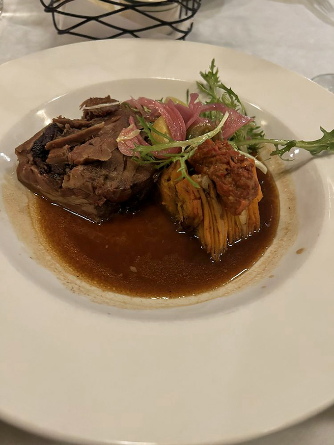 Braised lamb that falls apart with just a glance, nestled alongside what appears to be an artichoke preparation that would make vegetables the main event.