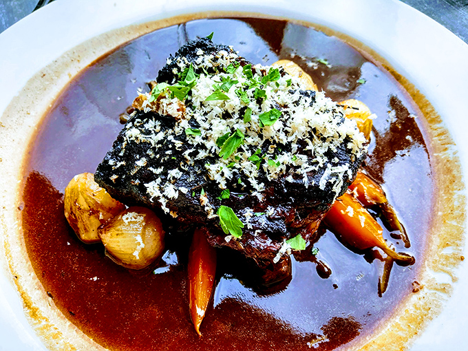 These short ribs aren't just falling off the bone&mdash;they're practically jumping onto your fork, swimming in a sauce so rich it probably has its own accountant.