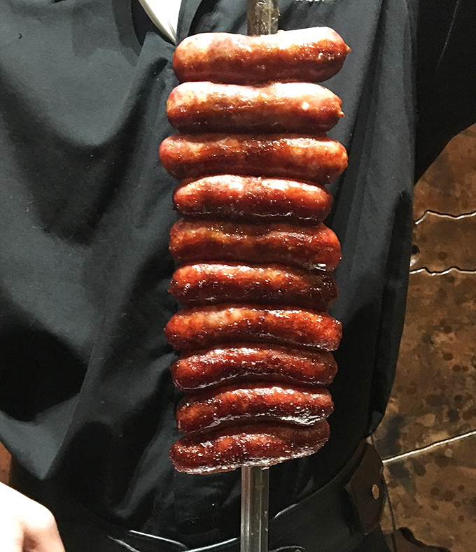 A skewer stacked with lingui&ccedil;a sausages stands like a meaty monument to Brazilian ingenuity. The snap when bitten is practically musical.